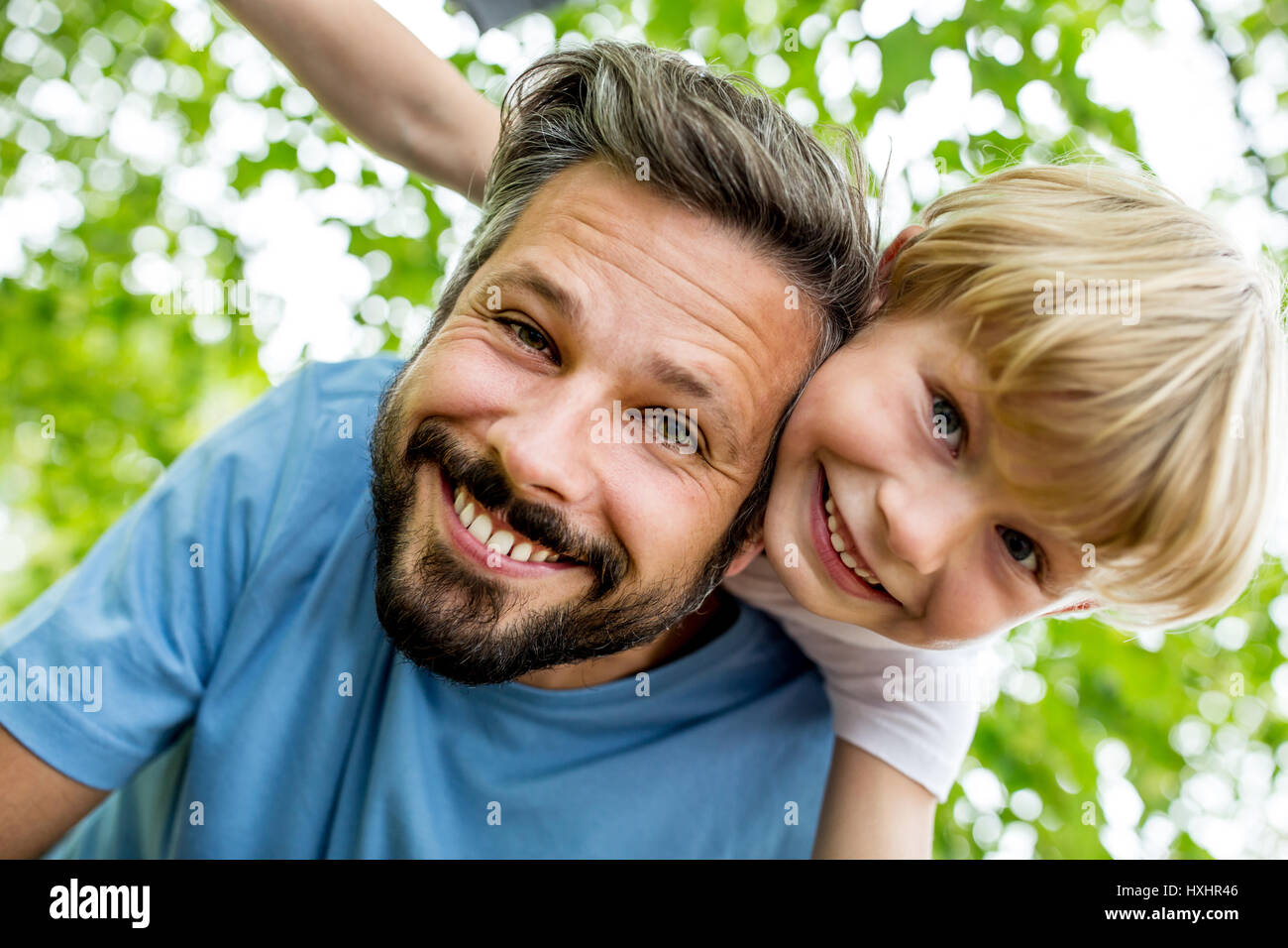 Father and son playing piggyback ride and having fun in the park Stock ...