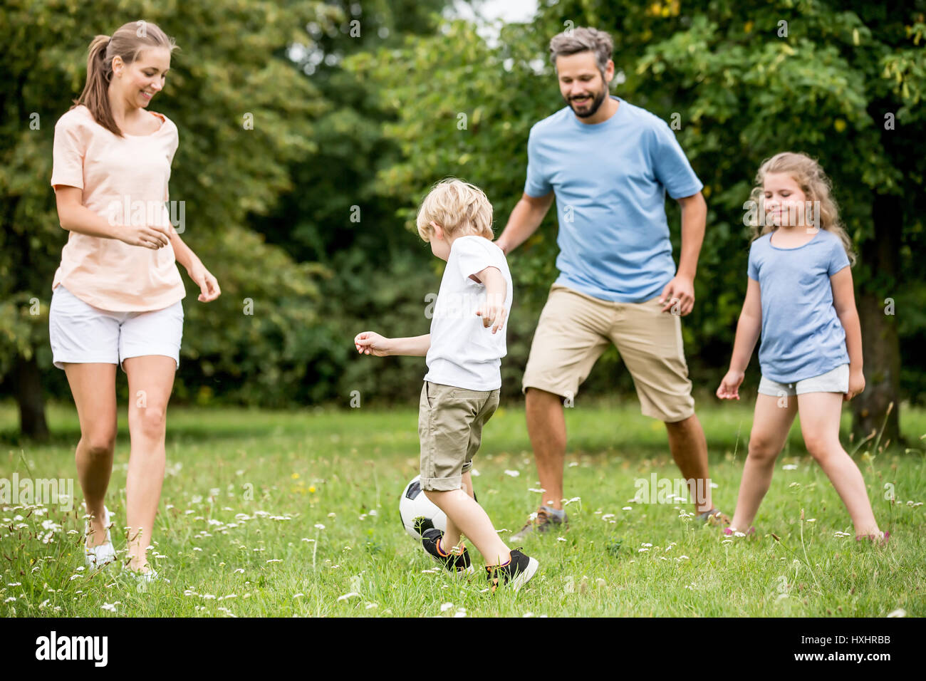 Family kids play soccer together hi-res stock photography and images ...