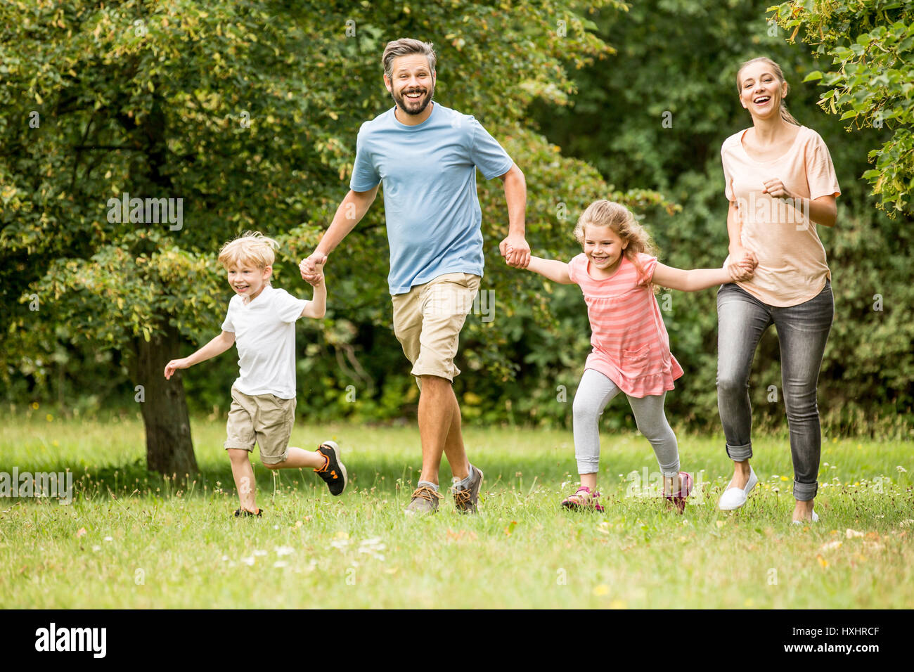 Happy family with two kids together in summer in the nature Stock Photo ...