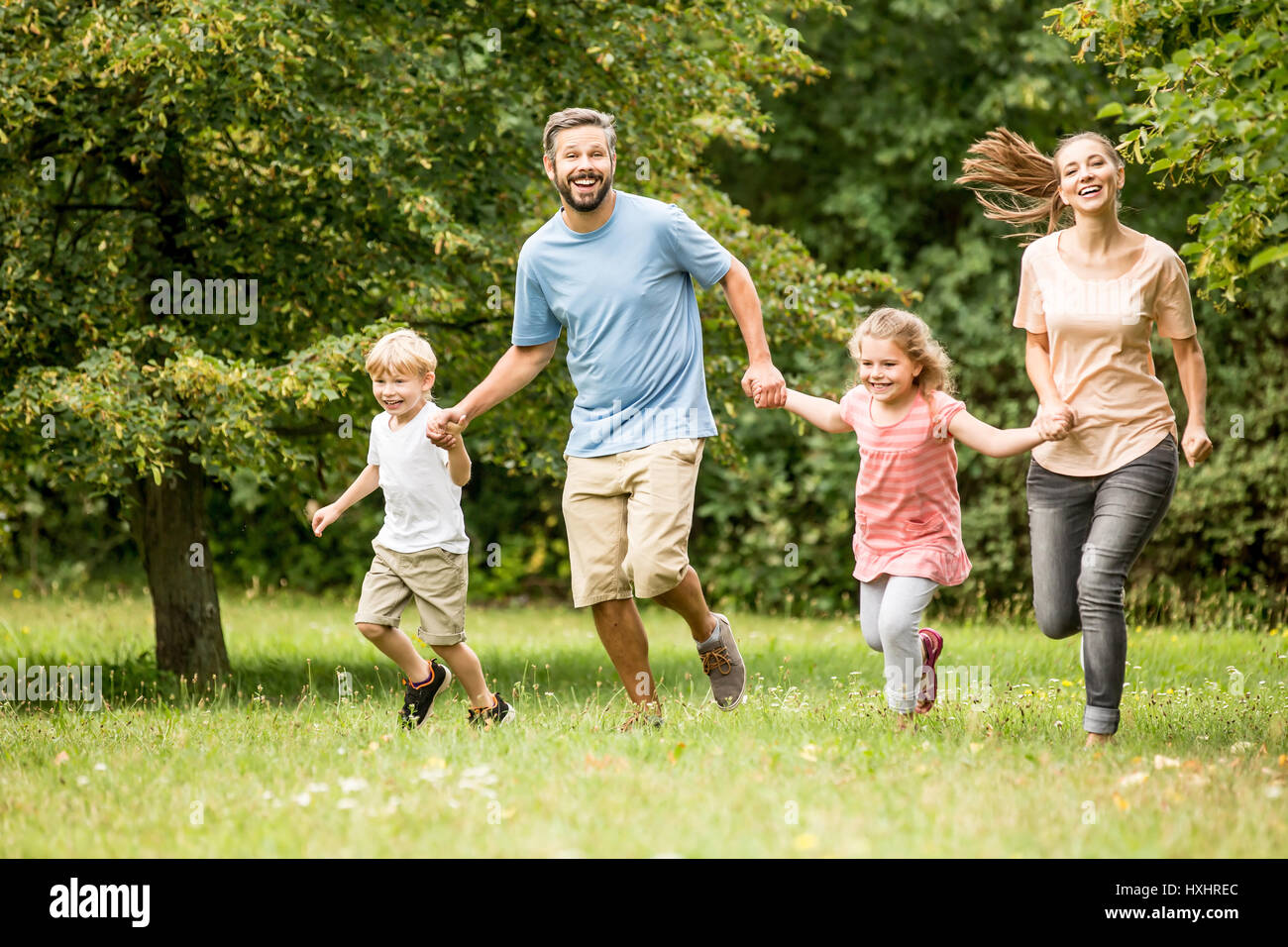Family with children enjoying summer activities at park Stock Photo - Alamy