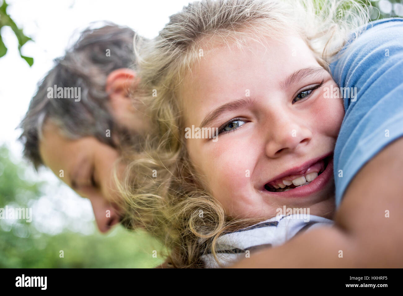Happy girl hugs dad with love in the park Stock Photo - Alamy