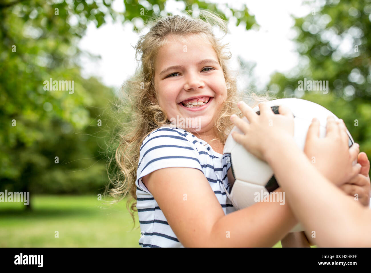 Girl with soccer ball having fun in the park Stock Photo - Alamy
