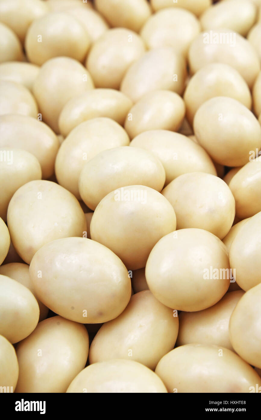 White chocolate balls. Chocolate drops as background texture pattern ...