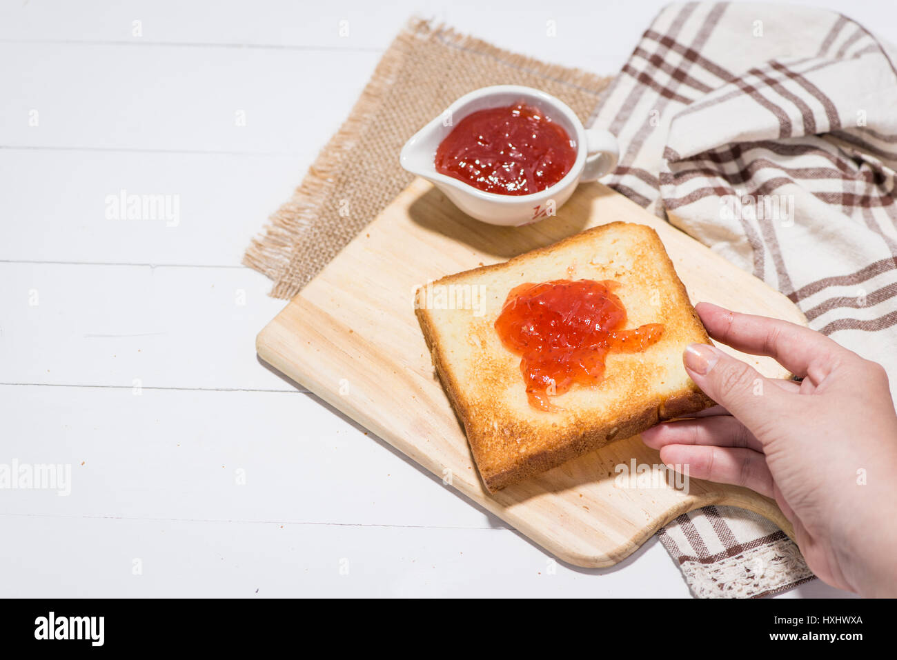 Woman spread jam on bread hi-res stock photography and images - Alamy