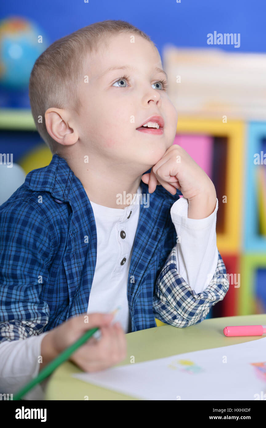 Boy drawing at the table Stock Photo - Alamy