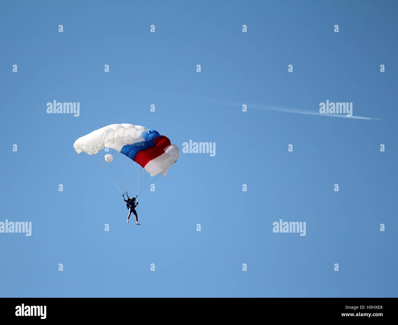 parachutist and airplane on blue sky Stock Photo - Alamy