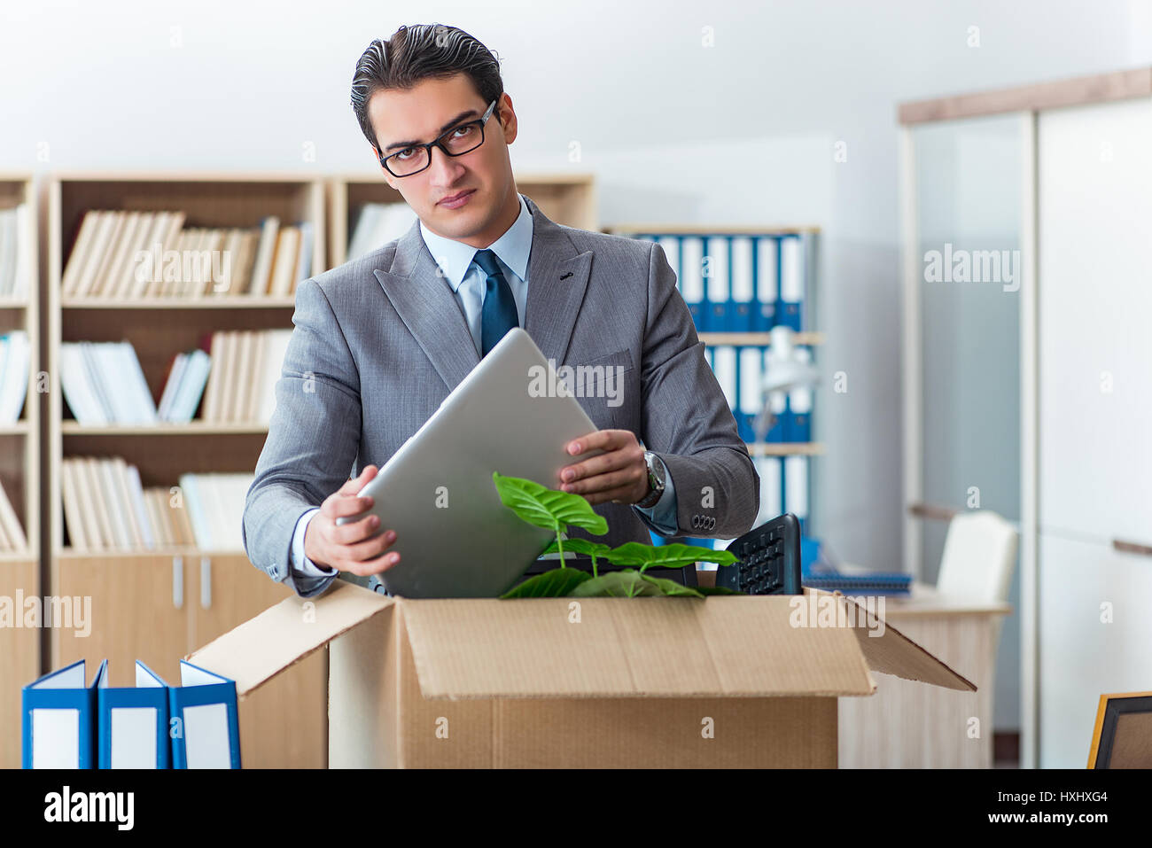 Man moving office with box and his belongings Stock Photo - Alamy