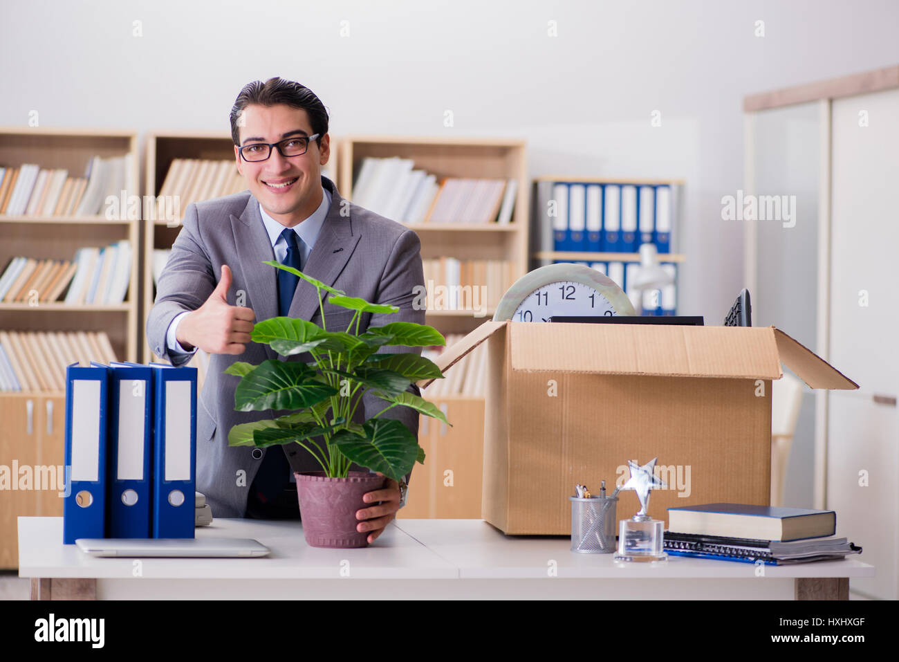 Man moving office with box and his belongings Stock Photo - Alamy