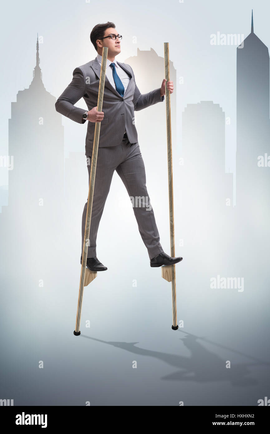 Businessman walking on stilts - standing out from the crowd Stock Photo ...