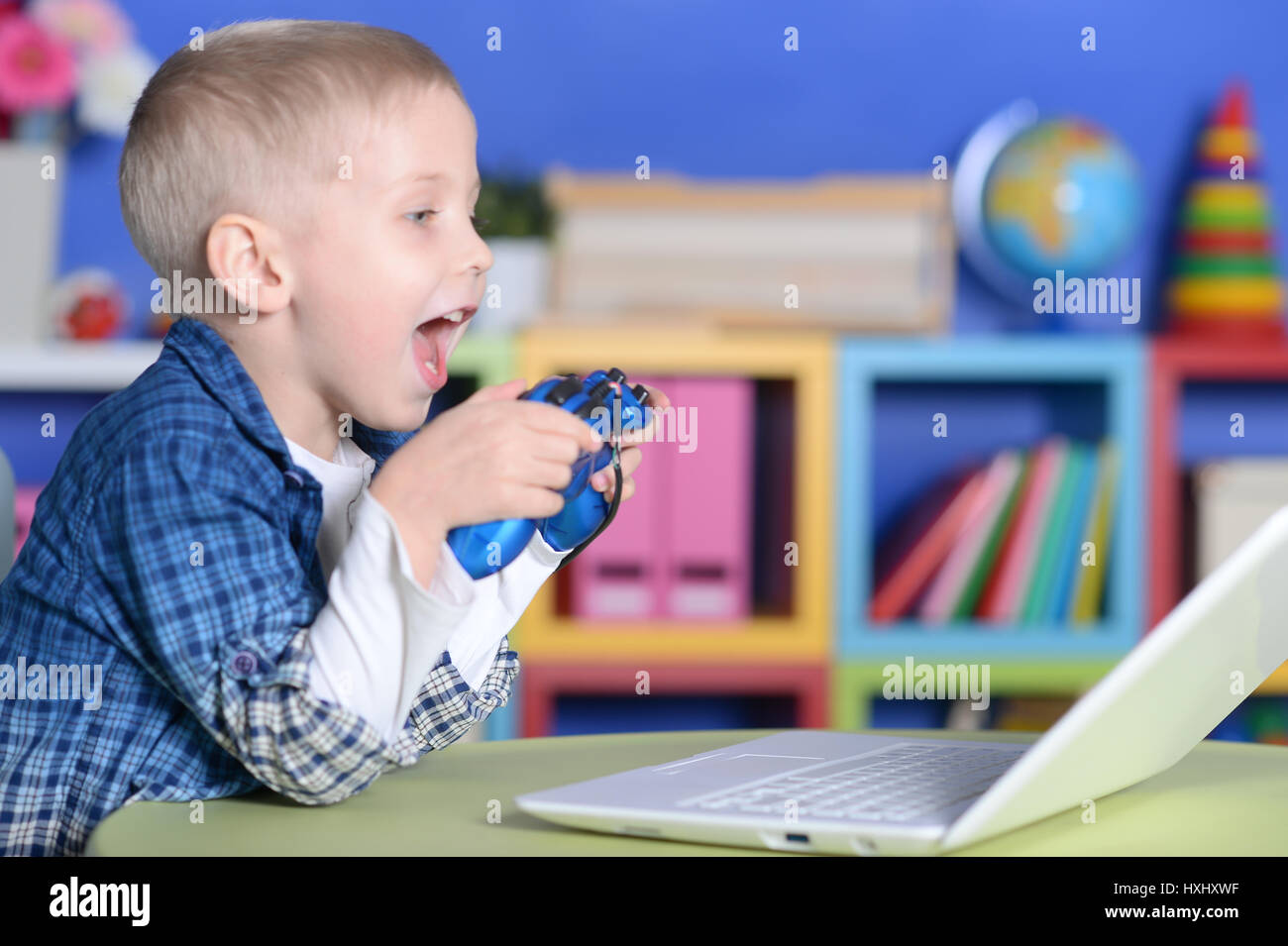 Boy playing a computer game Stock Photo - Alamy