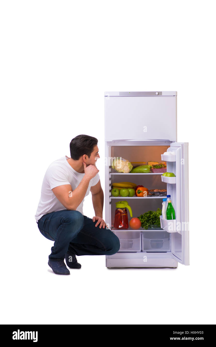 Man next to fridge full of food Stock Photo - Alamy
