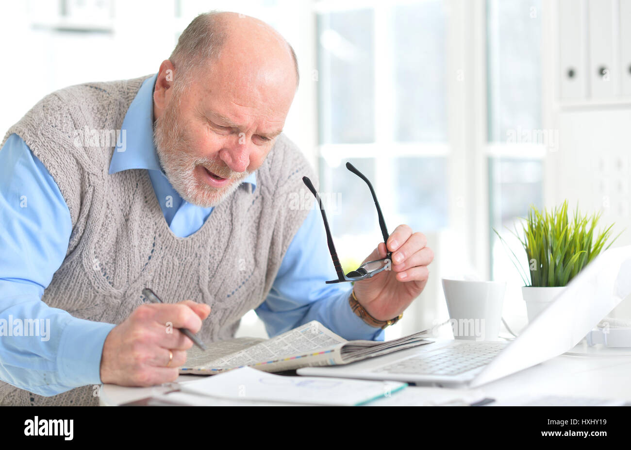 Elderly man with a laptop Stock Photo - Alamy