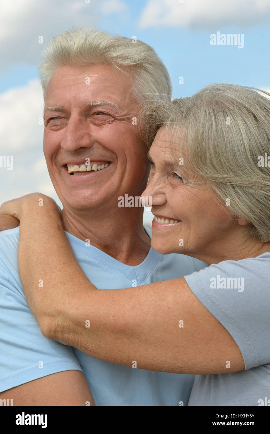 Happy elderly couple embracing Stock Photo - Alamy
