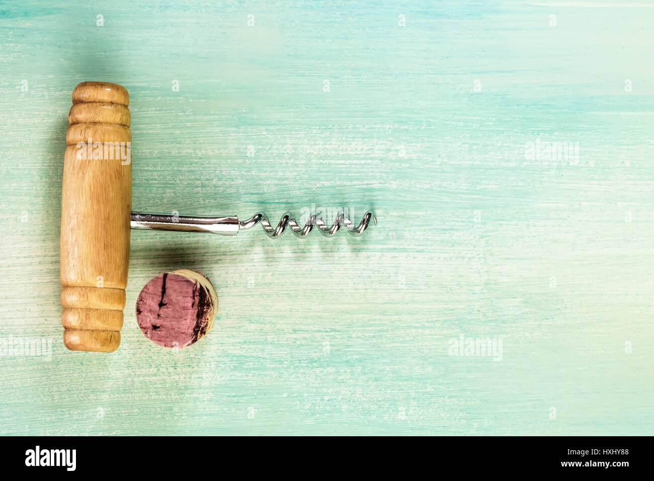 A photo of an old-fashioned corkscrew with a cork, shot from above on a ...