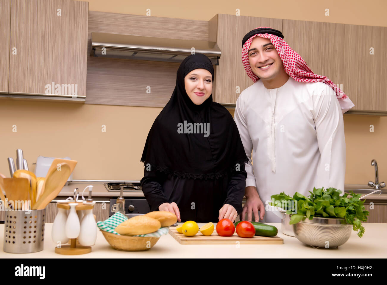 Young arab family in the kitchen Stock Photo - Alamy