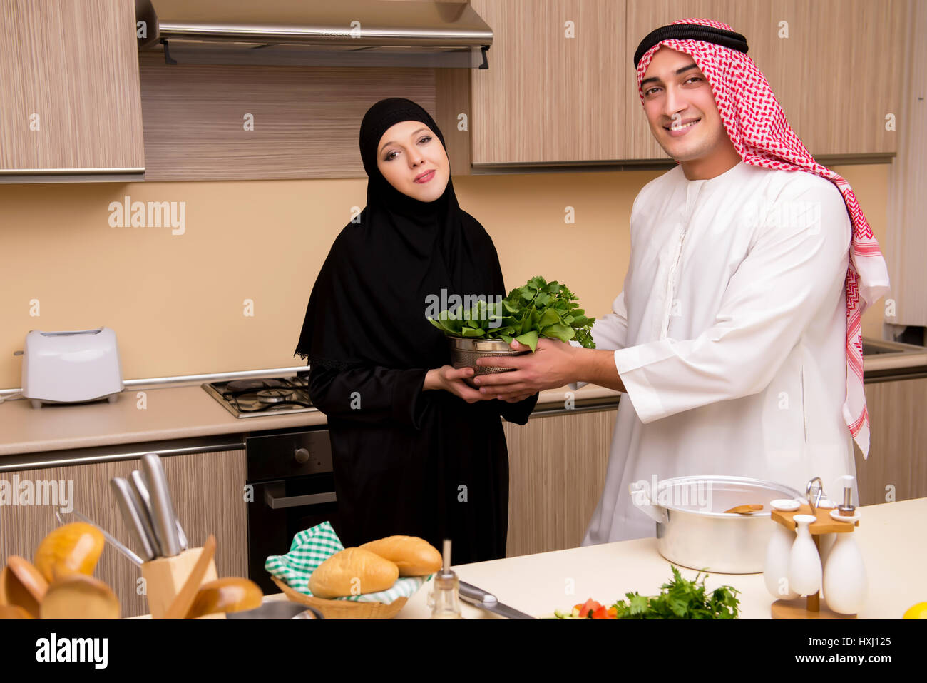 Young arab family in the kitchen Stock Photo - Alamy