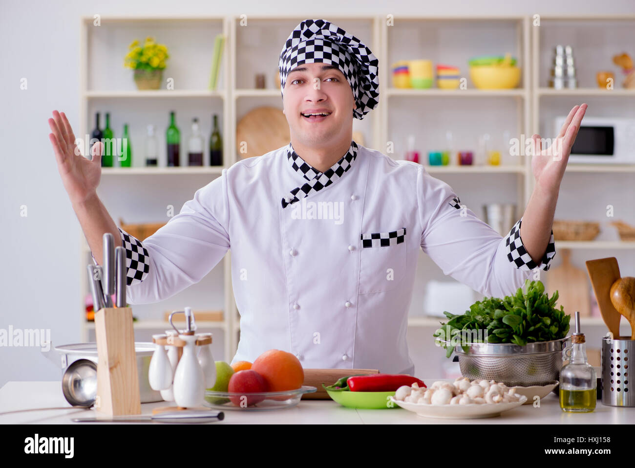 Young male cook working in the kitchen Stock Photo - Alamy