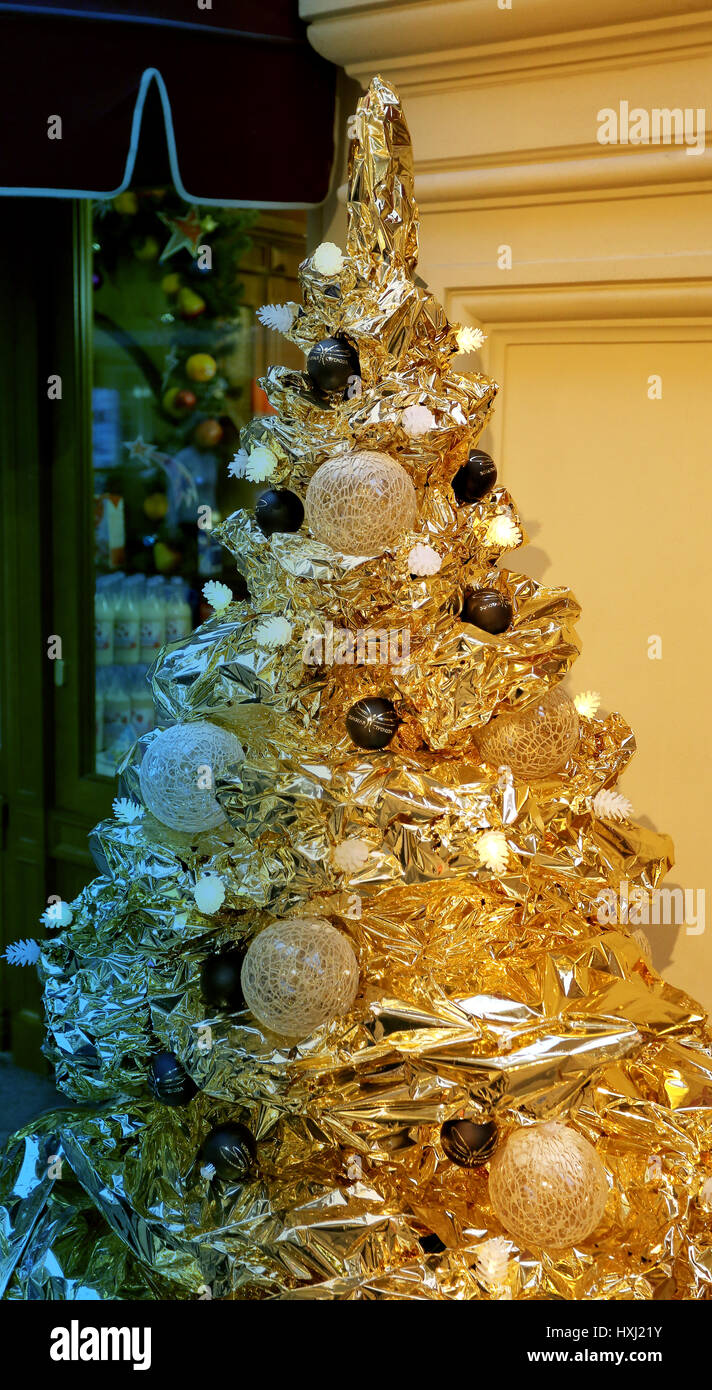 Beautiful gold Christmas tree with white balls photographed in close-up ...