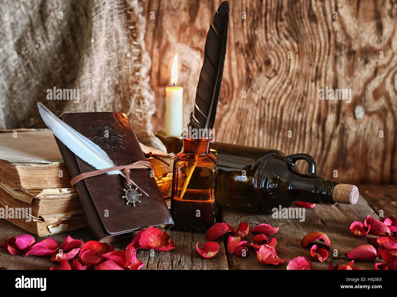 feather and book novel close to the a candle Stock Photo - Alamy