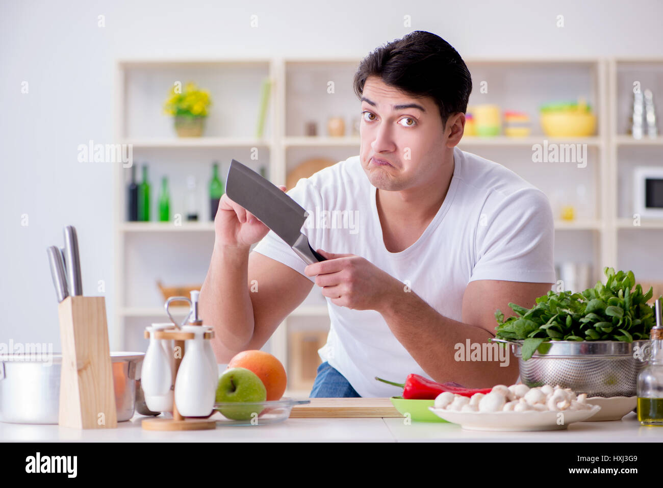 Young male cook working in the kitchen Stock Photo - Alamy