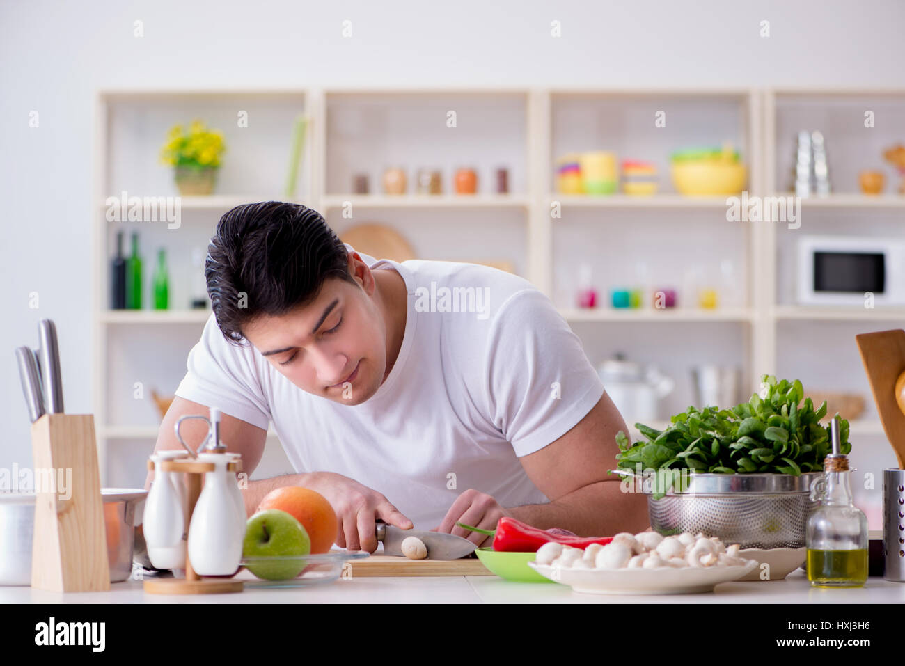 Young male cook working in the kitchen Stock Photo - Alamy