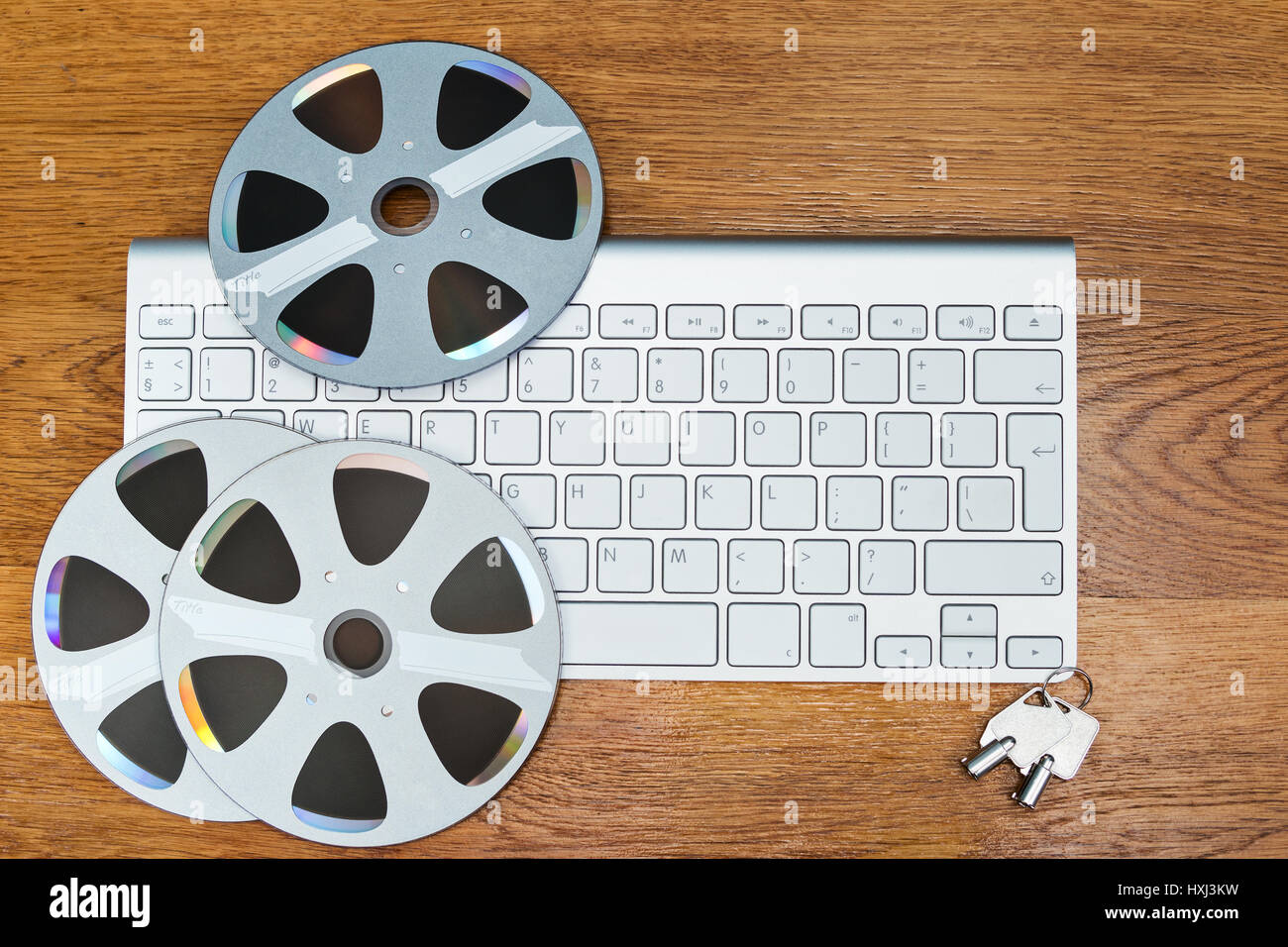 Compact disks in the form of old bobbins lie on the keyboard, on a ...