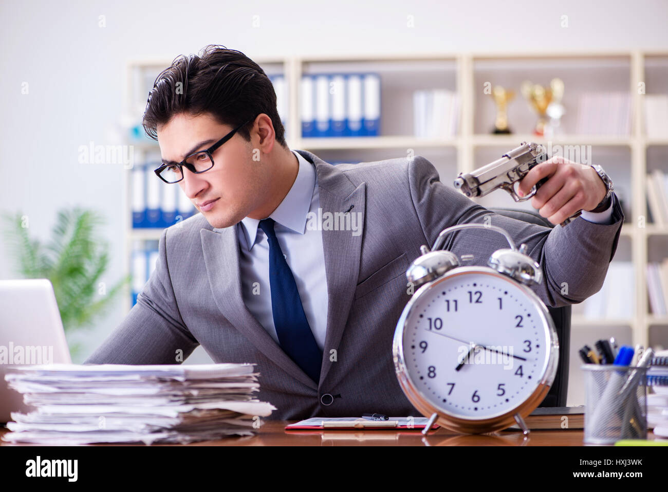 Young businessman in time management concept Stock Photo - Alamy