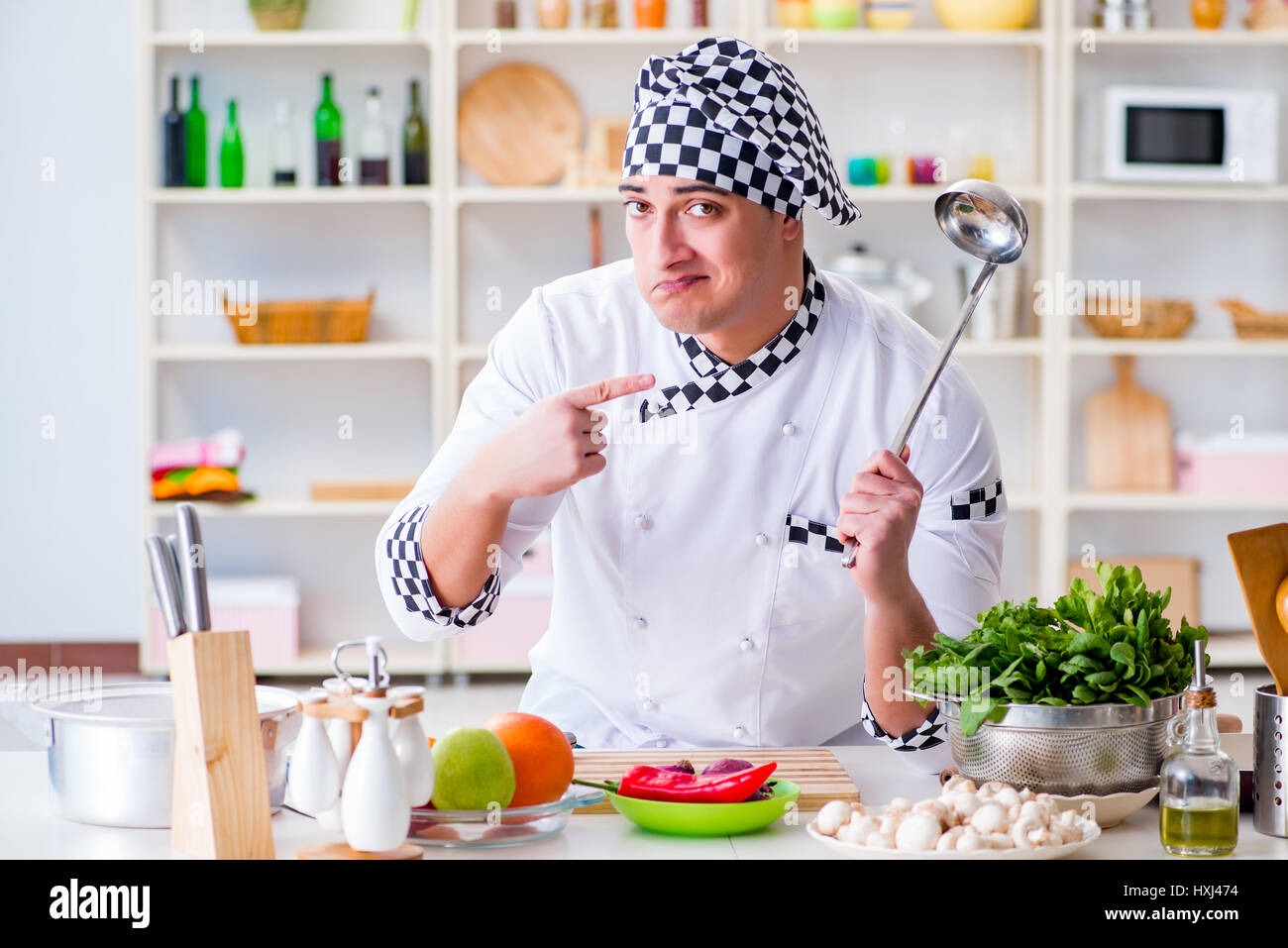 Young male cook working in the kitchen Stock Photo - Alamy