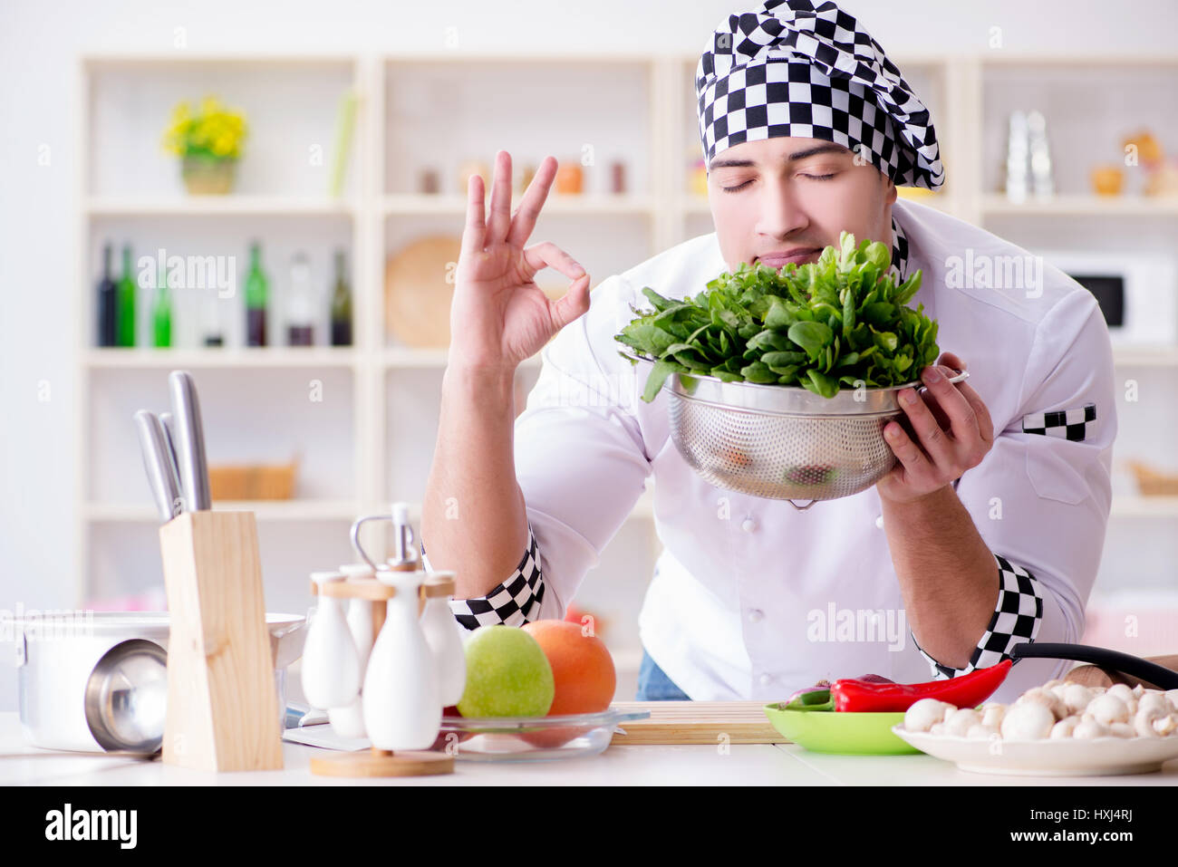 Young male cook working in the kitchen Stock Photo - Alamy