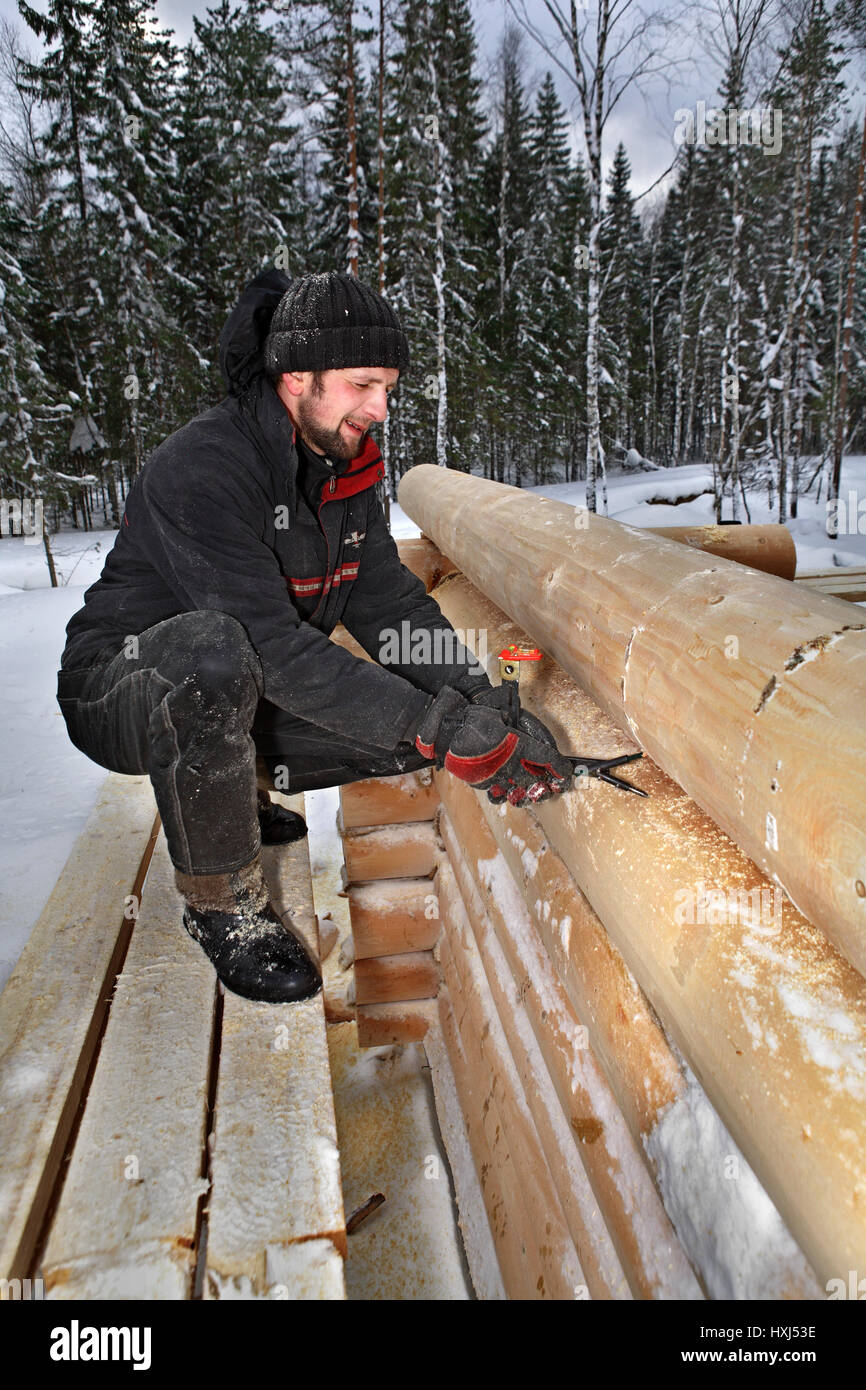 Leningrad Region, Russia - February 2, 2010: Woodworker using scriber ...
