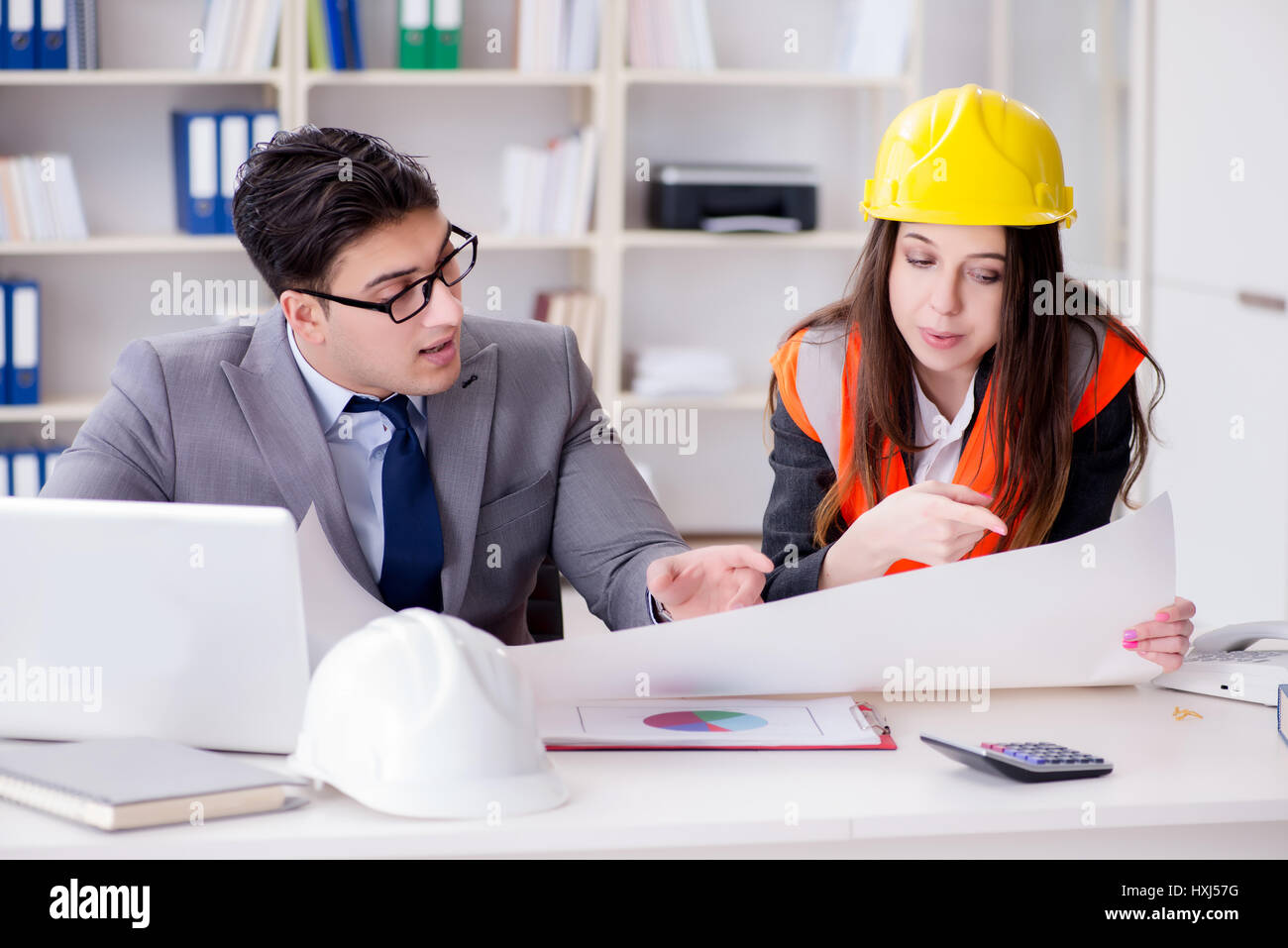 Construction foreman supervisor reviewing drawings Stock Photo - Alamy