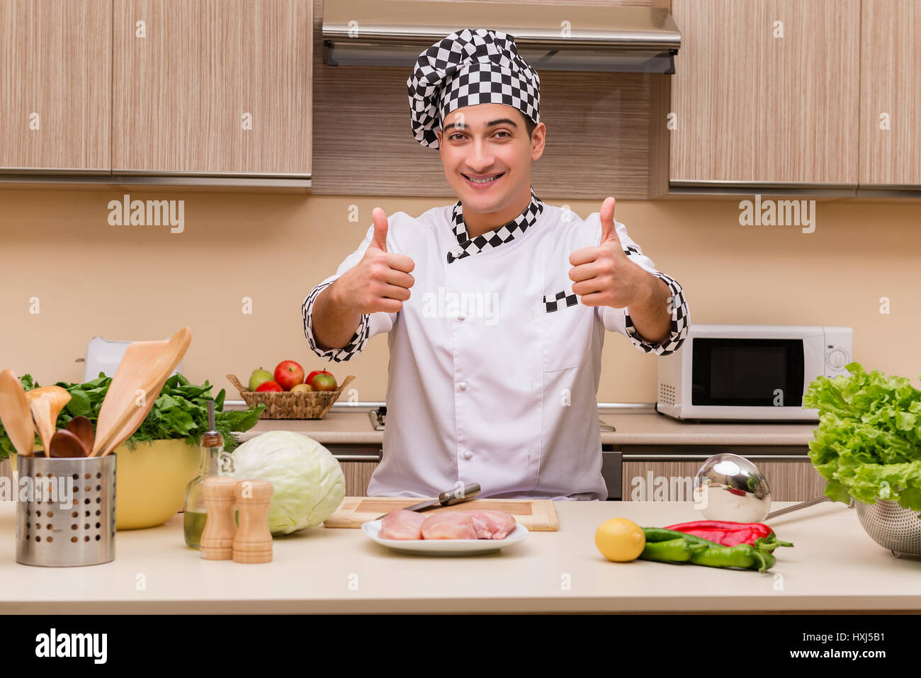 Young chef working in the kitchen Stock Photo - Alamy