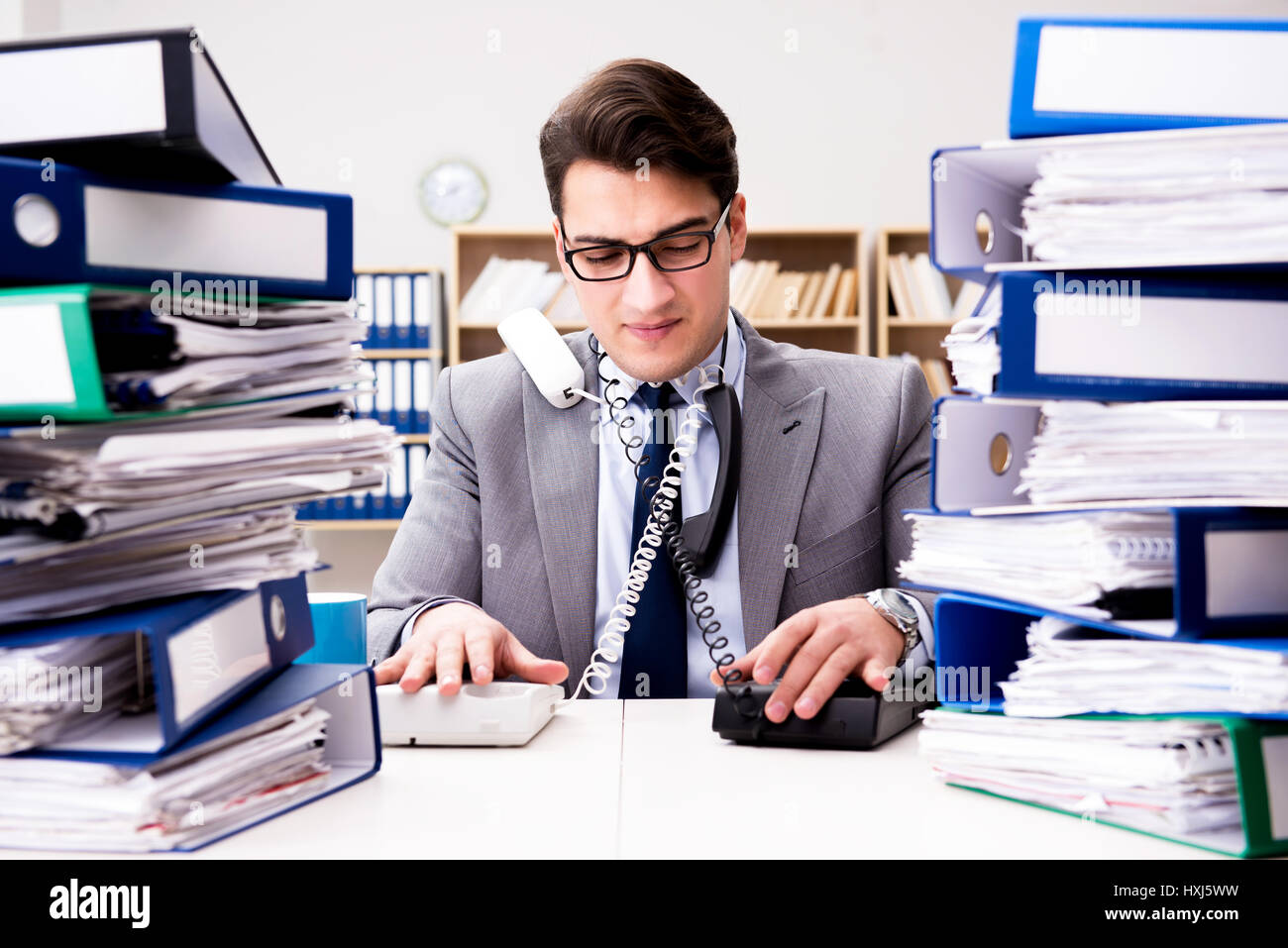 Busy businessman under stress due to excessive work Stock Photo - Alamy