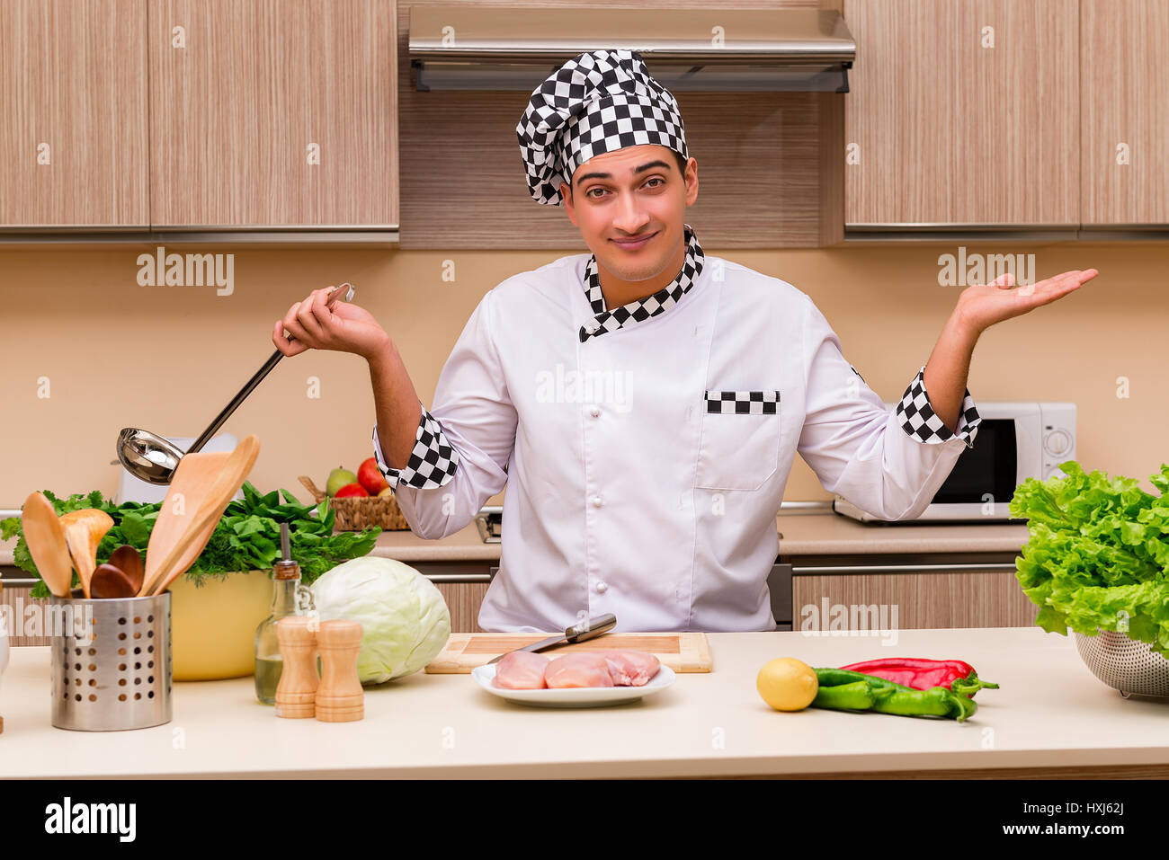 Young chef working in the kitchen Stock Photo - Alamy