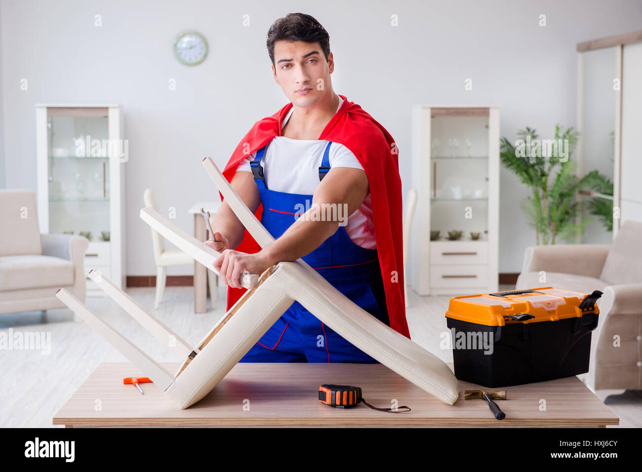 Superhero repairman with tools in repair concept Stock Photo - Alamy