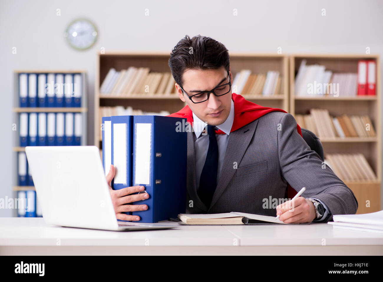 Superhero businessman working in the office Stock Photo - Alamy