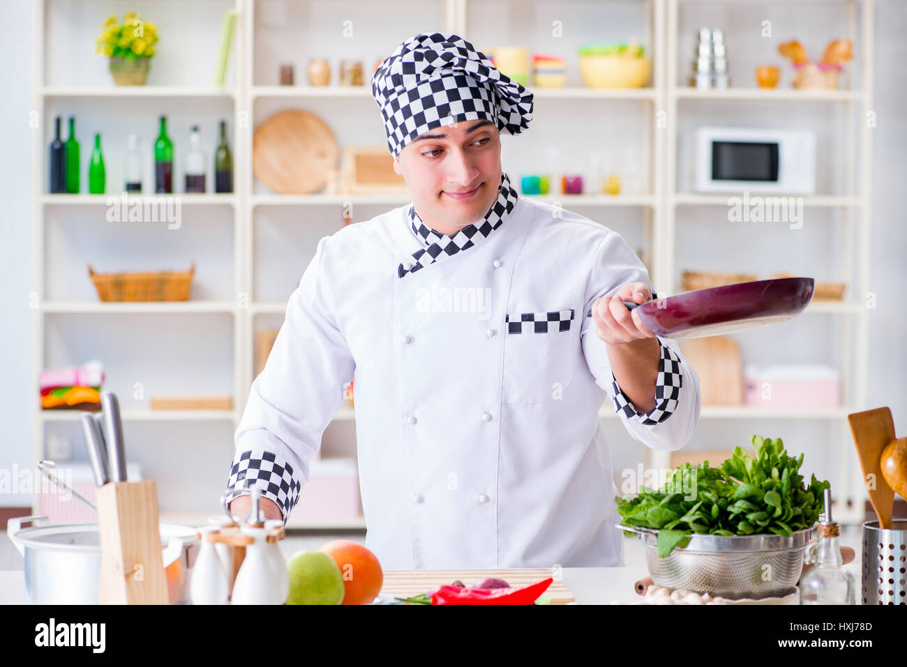 Young male cook working in the kitchen Stock Photo - Alamy