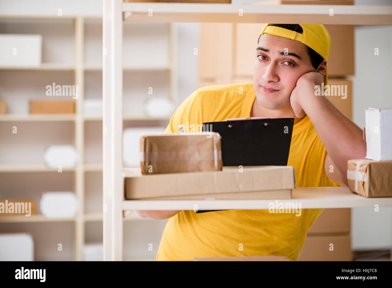 Man working in postal parcel delivery service office Stock Photo - Alamy