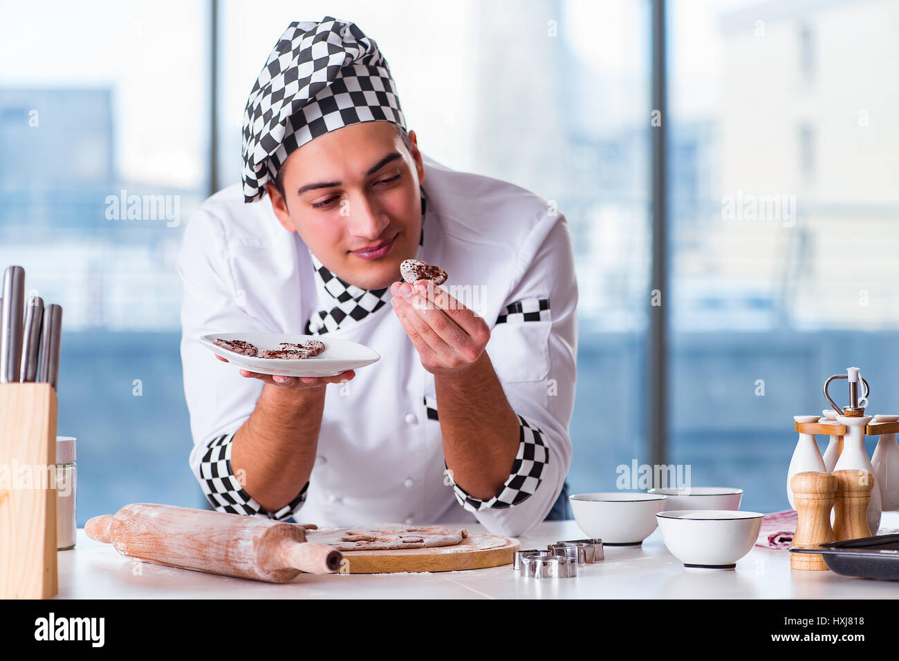Young man cooking cookies in kitchen Stock Photo - Alamy