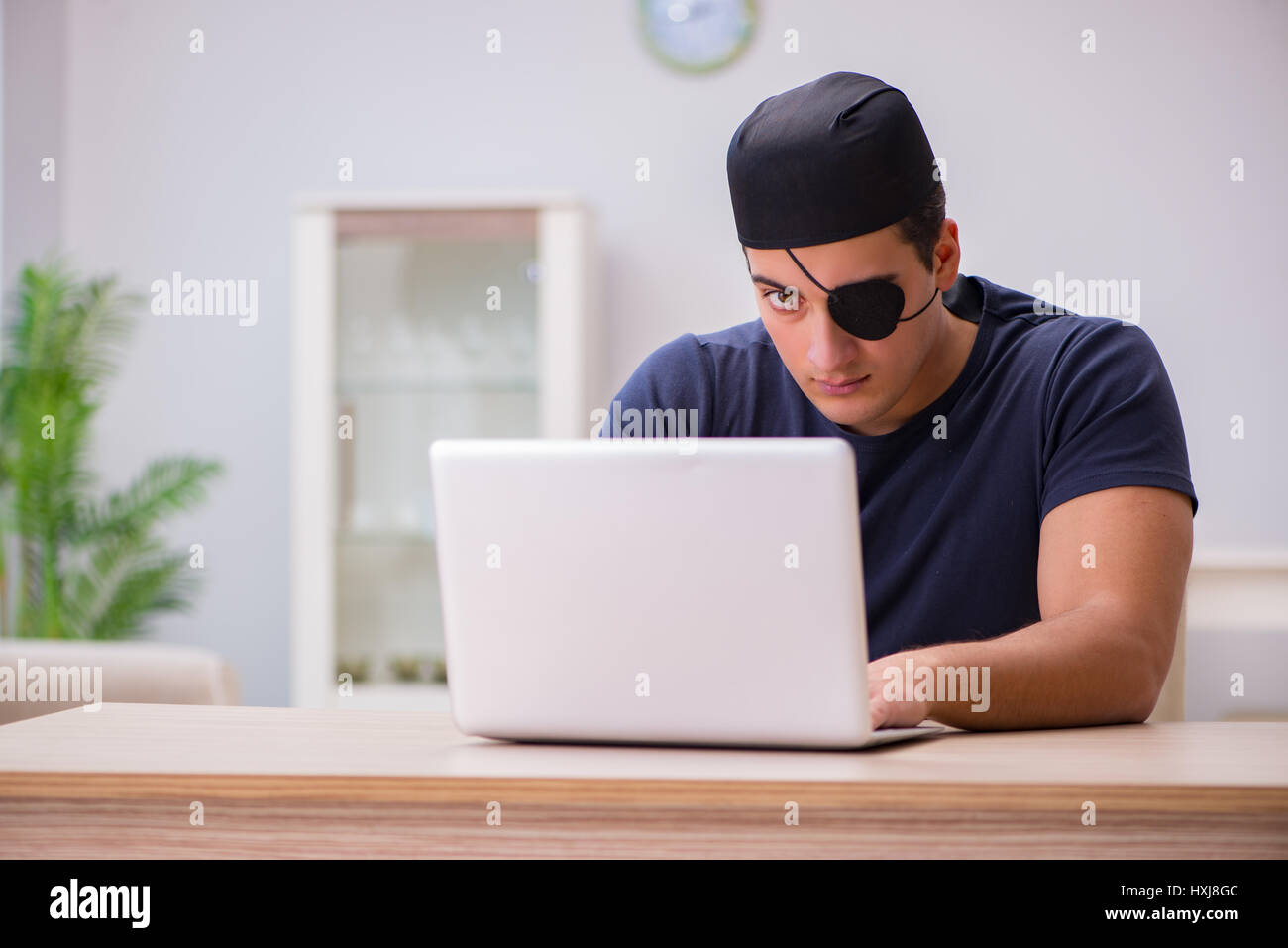 Digital security concept with pirate at computer Stock Photo - Alamy