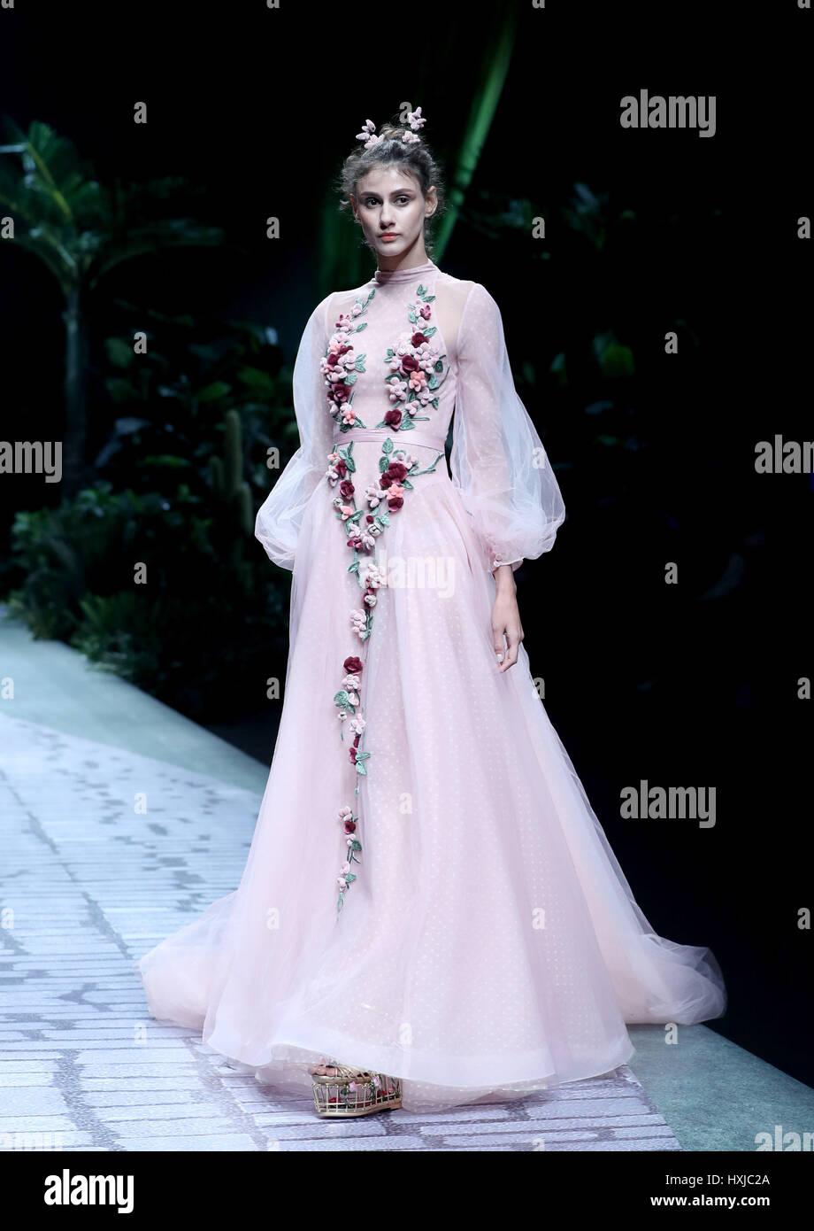 Beijing, China. 28th Mar, 2017. A model presents a creation of wedding ...