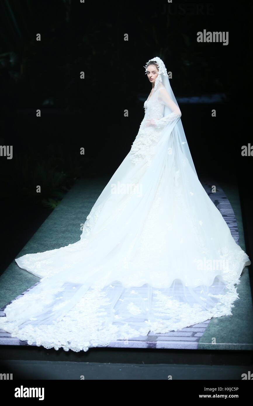 Beijing, China. 28th Mar, 2017. A model presents a creation of Yu ...