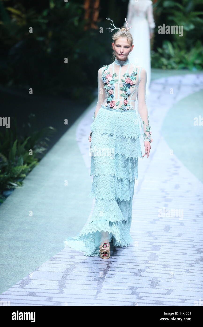 Beijing, China. 28th Mar, 2017. A model presents a creation of Yu ...