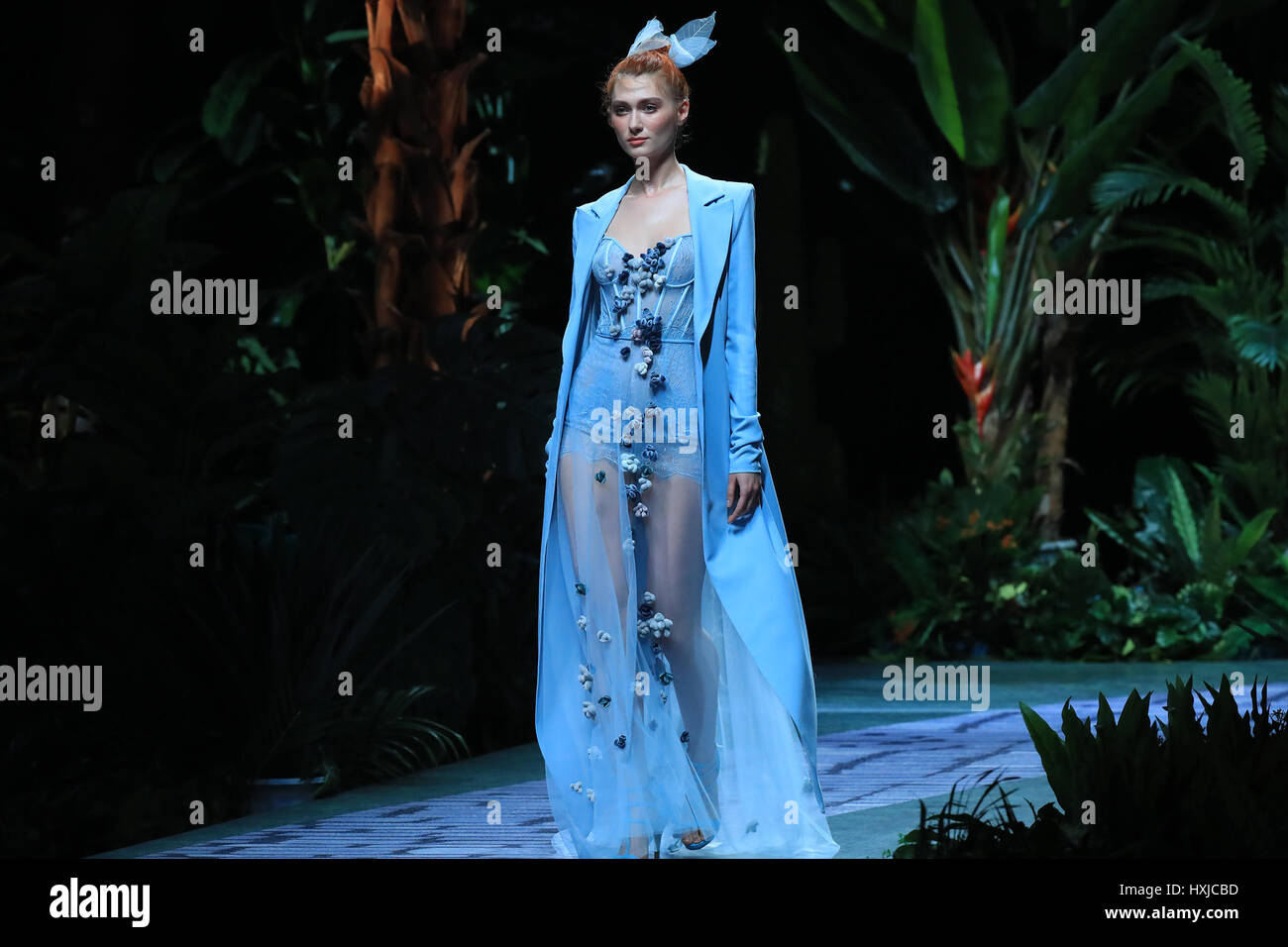 Beijing, China. 28th Mar, 2017. A model presents a creation by Chinese ...