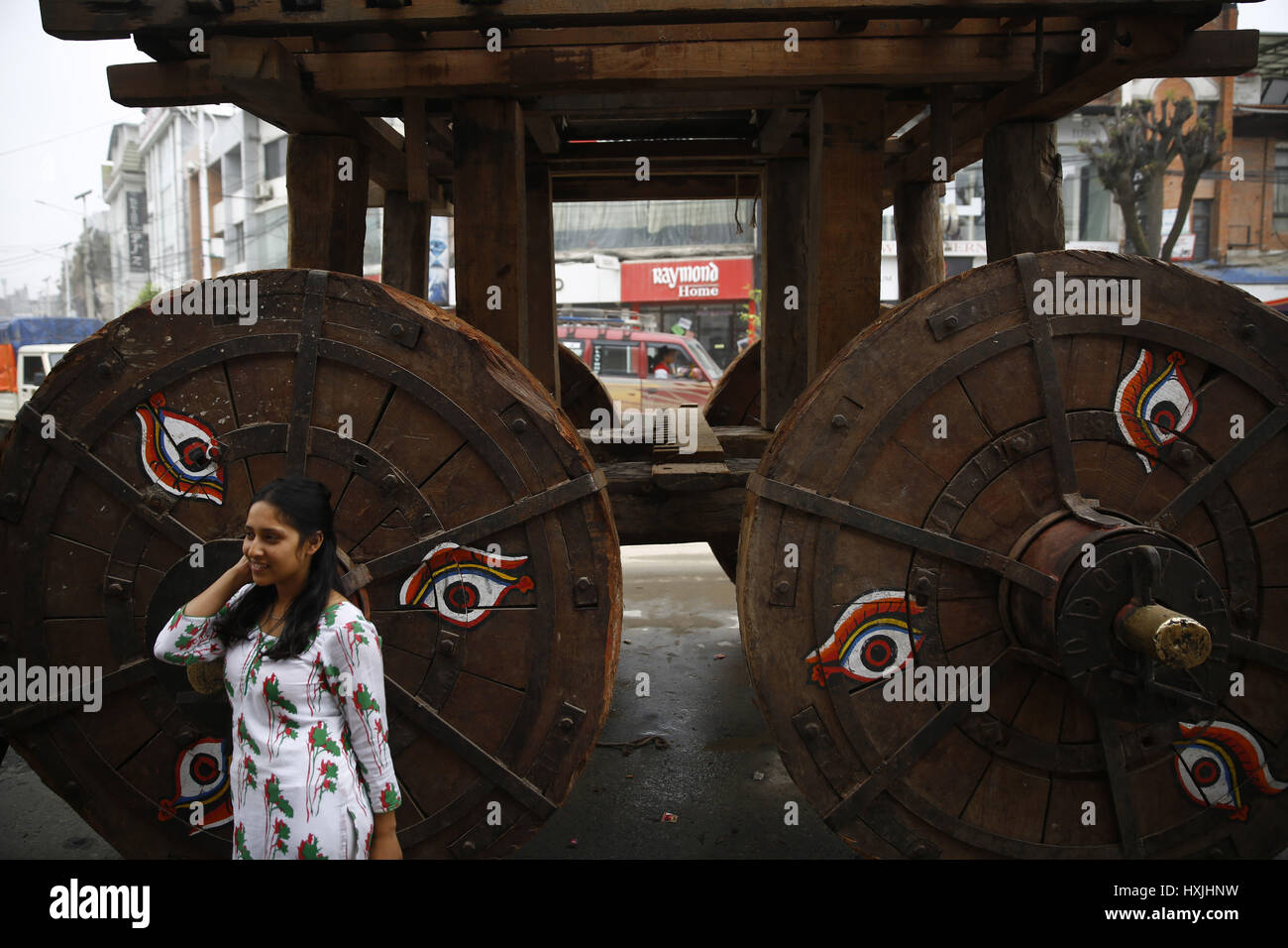 Kathmandu, Nepal. 29th Mar, 2017. A Nepalese woman rests on the wheels ...