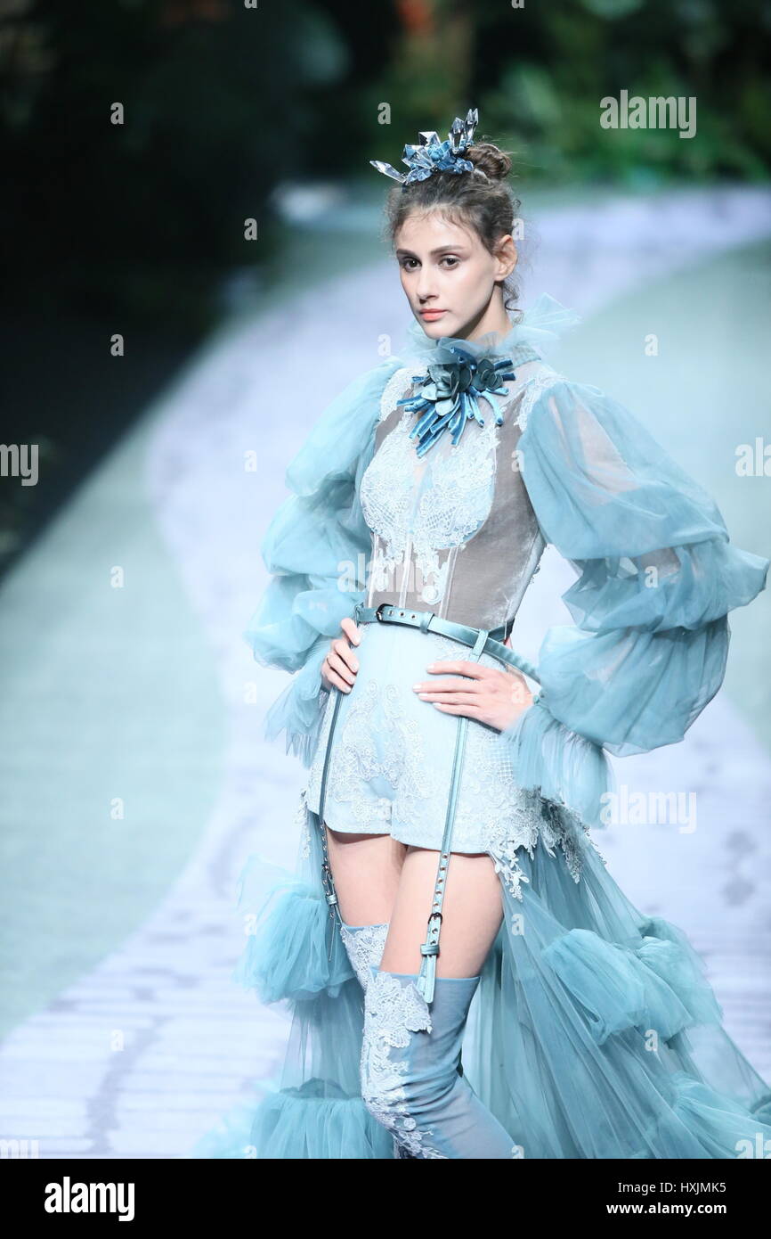 Beijing, China. 28th Mar, 2017. A model presents a creation of Yu ...