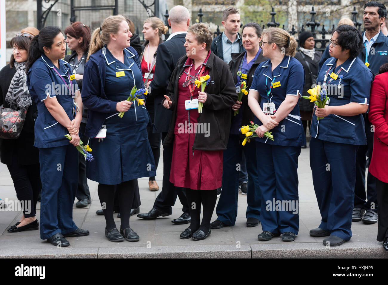 London, UK. 29th Mar, 2017. National Health Service nurses hold flowers ...