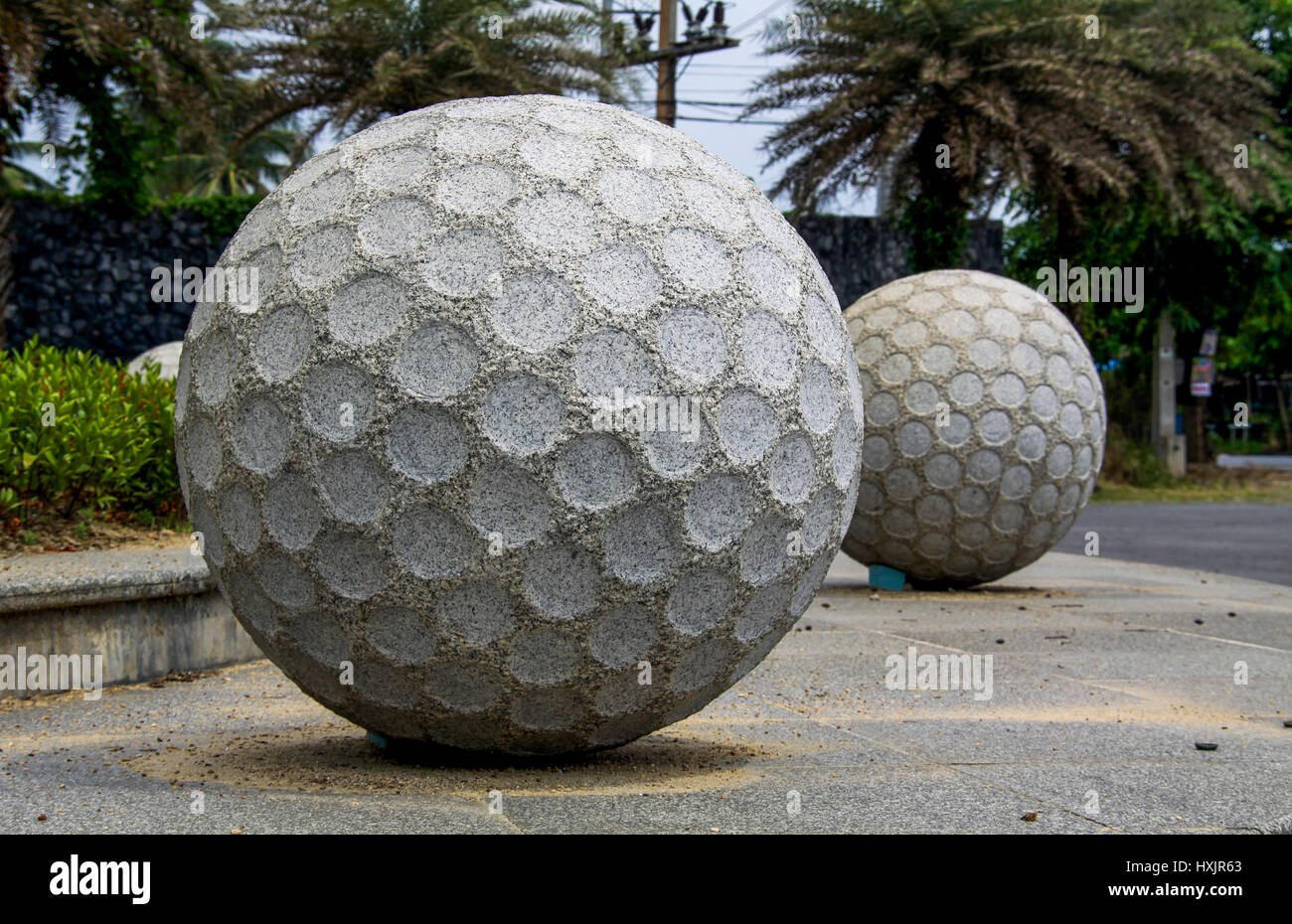 statue of stone golf ball on cement floor Stock Photo - Alamy