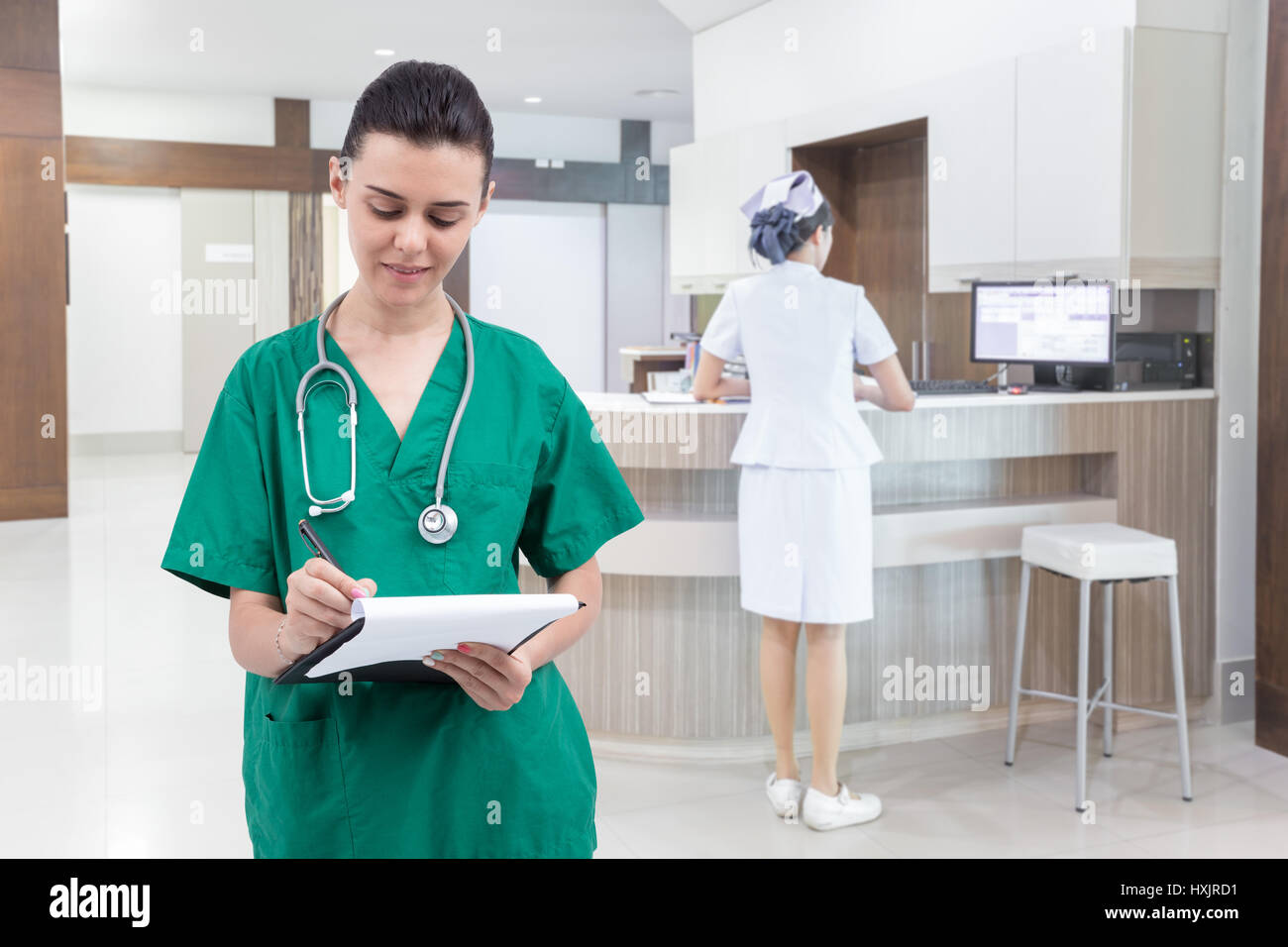 Nurse writing a medical record in the hospital Stock Photo - Alamy