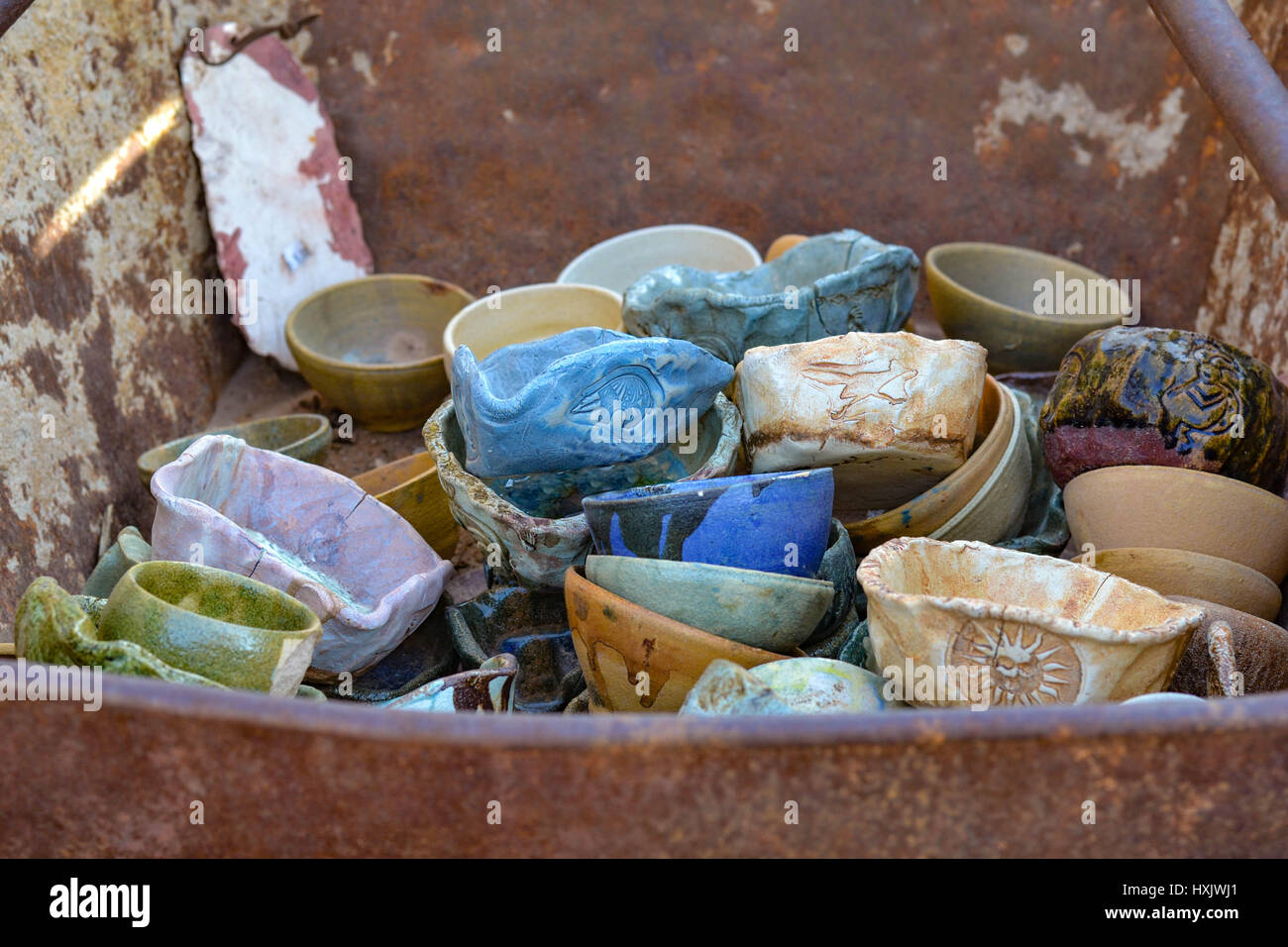handmade clay bowls in a rusty wheel barrel Stock Photo - Alamy